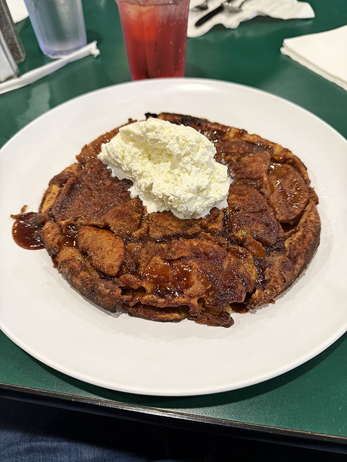 Not just a pancake—it's an architectural marvel with whipped cream clouds. Breakfast or dessert? Why choose?