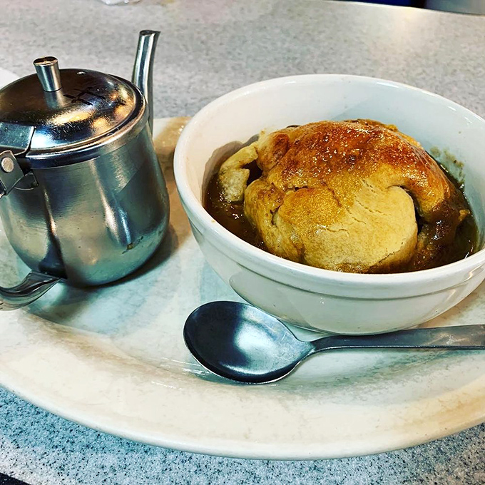 The apple dumpling that launched a thousand food pilgrimages. That metal creamer isn't for coffee—it's for pouring warm sweet cream over pastry perfection.