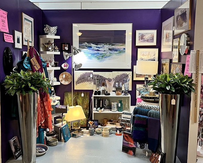 Purple walls frame an eclectic wonderland where seascapes meet curiosities in perfect vintage harmony.