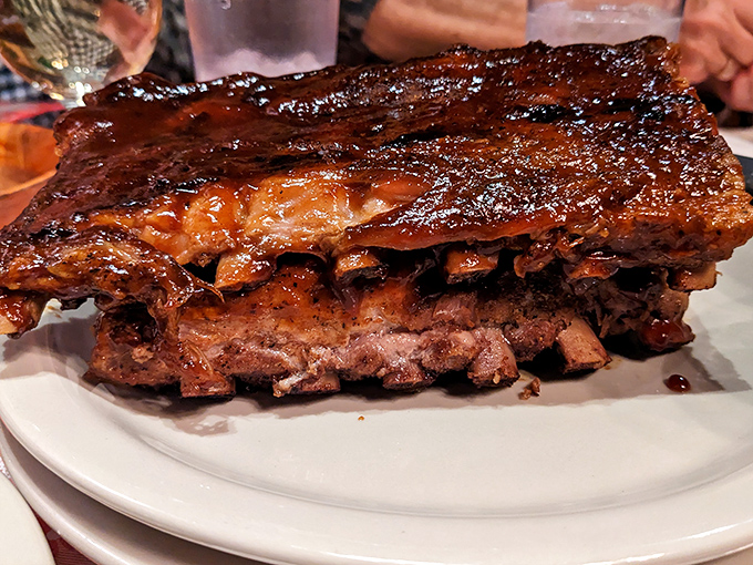 These aren't just ribs—they're prehistoric, Fred Flintstone-worthy slabs of smoky perfection that'll have you questioning why you ever bothered with a knife.