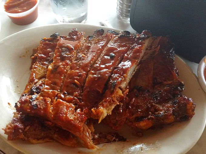 These ribs don't just fall off the bone—they practically leap onto your fork, glistening with that perfect lacquer of sauce.