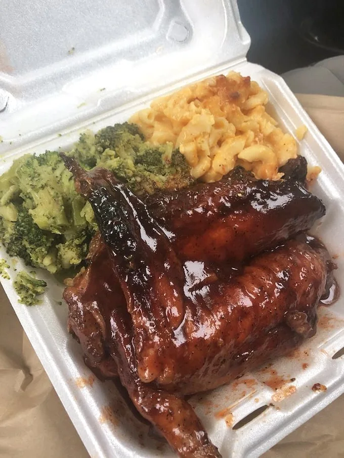 BBQ turkey wings glistening with sauce, accompanied by broccoli and mac and cheese – comfort food elevated to an art form.