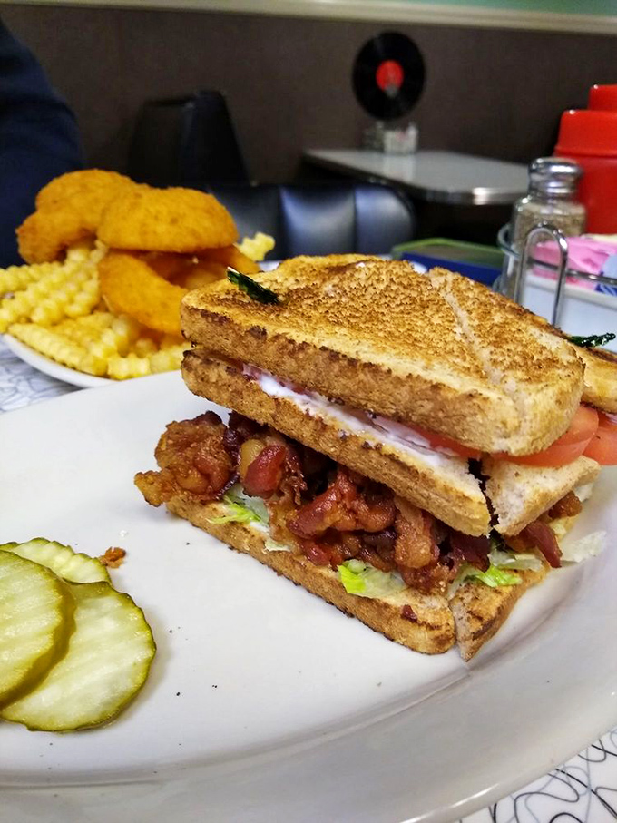 This triple-decker sandwich isn't just lunch—it's an engineering marvel that requires both hands, several napkins, and zero regrets.