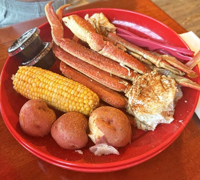 Snow crab legs, corn on the cob, and red potatoes—the holy trinity of coastal dining presented on a plate that screams "you're going to need that bib."