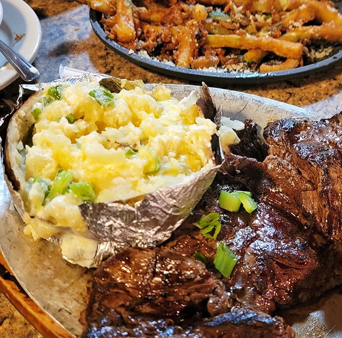 When a baked potato comes loaded with green onions and cheese, it's not just a side dish – it's making a compelling case for co-star status.