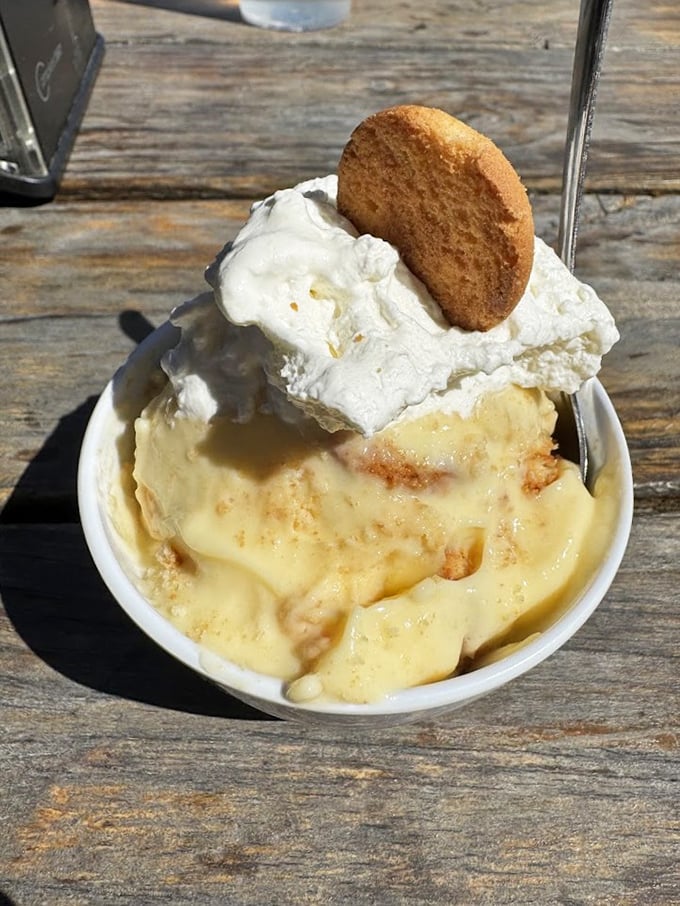 Banana pudding that would make your grandmother both proud and suspicious you stole her recipe. That vanilla wafer is just waiting for its pudding plunge.
