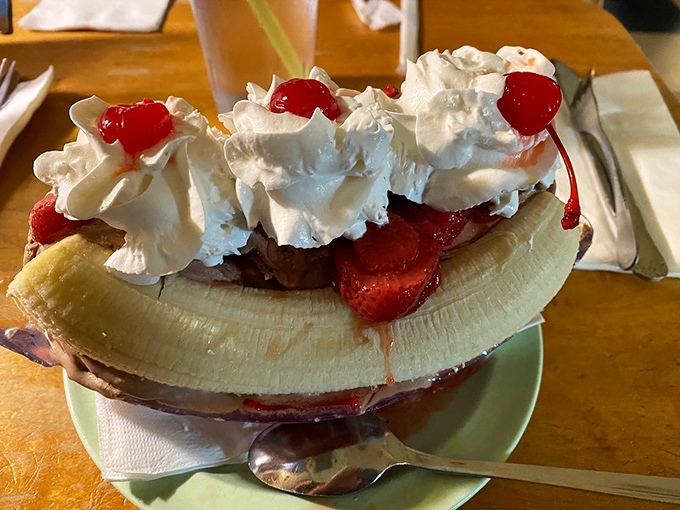 This banana split isn't just dessert, it's architecture – a carefully constructed monument to the holy trinity of fruit, cream, and excessive toppings.