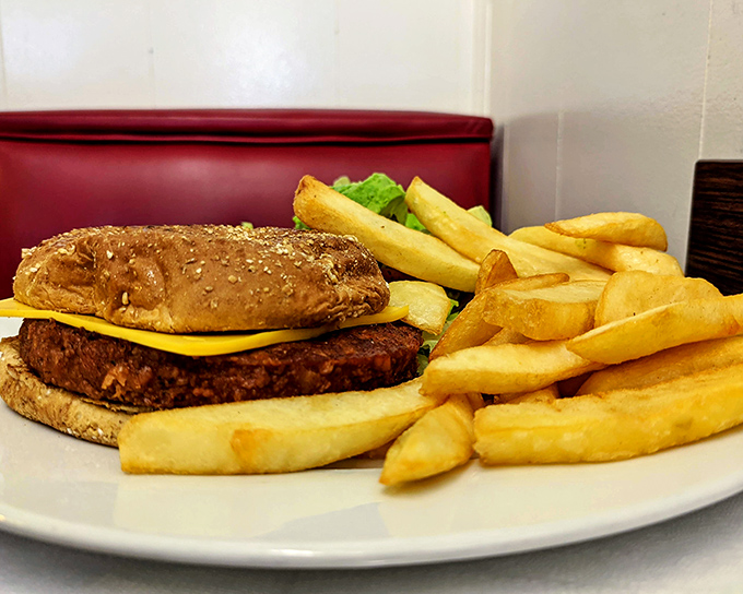 A burger that doesn't need Instagram filters or fancy toppings—just honest cooking on a well-seasoned griddle that's seen more history than most history books.