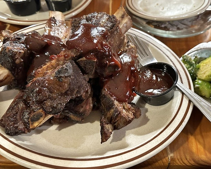 These ribs aren't just falling off the bone—they're practically jumping onto your fork, glazed with a sauce worth bottling and taking home.