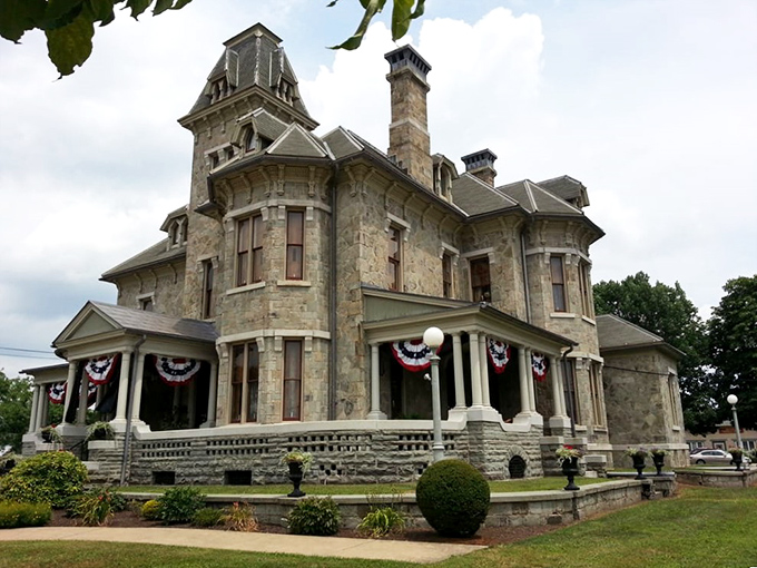 This magnificent stone mansion looks like it should be on a historic home tour. Victorian architecture at its finest, complete with patriotic bunting.