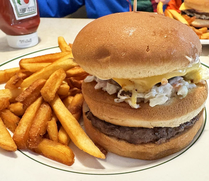 The "Big Bud" burger towers like a delicious skyscraper, proving that sometimes bigger really is better.