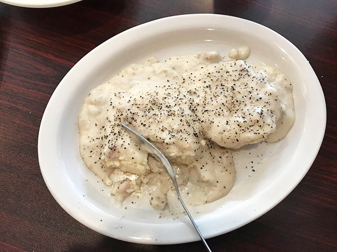 Biscuits and gravy so creamy they could make a Southern grandmother weep with joy. The pepper flecks aren't just decoration—they're little flavor bombs.