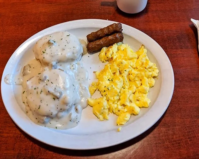 Breakfast of champions or hangover cure? These biscuits smothered in creamy country gravy alongside scrambled eggs might just be both—comfort on a plate.