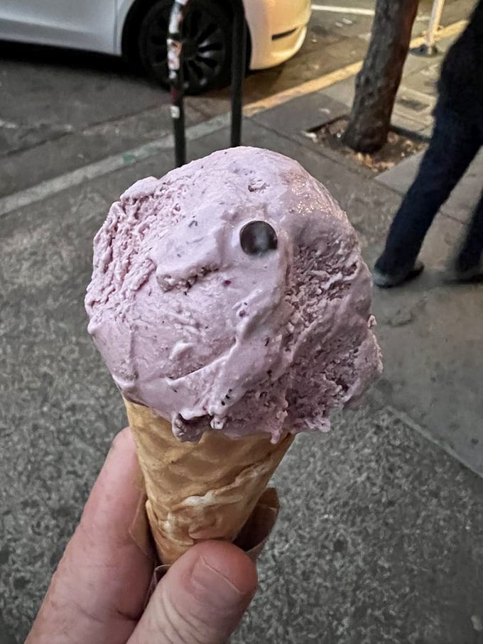 This purple-hued scoop isn't just ice cream—it's a berry revelation with chocolate punctuation marks.