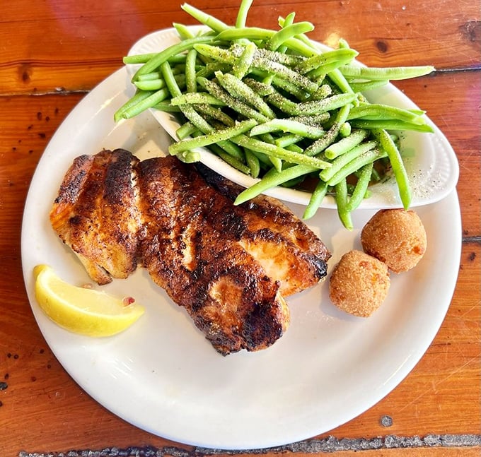 Blackened grouper that would make Neptune himself jealous. Paired with vibrant green beans and hush puppies that demand to be dunked.