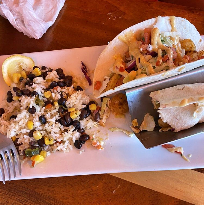 Blackened shrimp tacos with a side of vacation memories. That rice and bean mixture isn't just a side—it's practically its own attraction.
