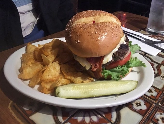 This isn't just a burger—it's a commitment. The pickle spear stands like a flag planted on a delicious mountain of beef, bacon, and melted cheese.