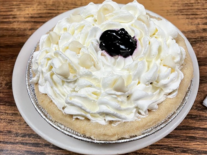 This cream pie isn't just dessert—it's a cloud of nostalgia topped with a dollop of blueberry joy that would make any pie skeptic a believer.