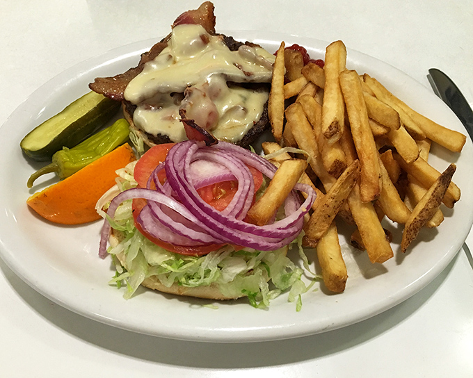This isn't just a burger—it's architecture with cheese, where every layer from the melty top to the garden-fresh fixings plays its perfect role.