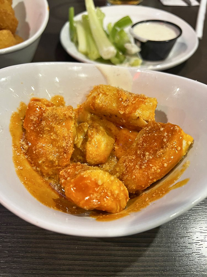 These boneless wings glisten with sauce like tiny flavor bombs waiting to detonate on your taste buds. No napkin will be left unused.
