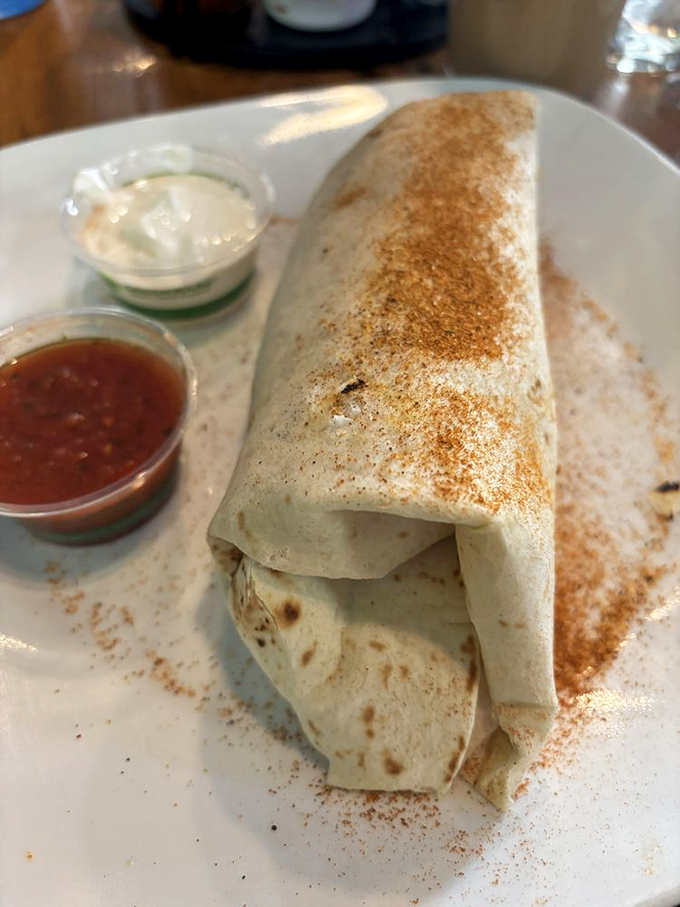 This breakfast burrito isn't just wrapped, it's embraced—a warm hug of tortilla cradling morning goodness with a sprinkle of cinnamon charm.