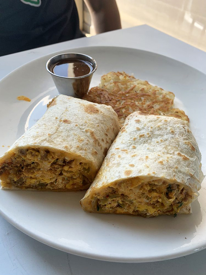This breakfast burrito isn't messing around—it's the heavyweight champion of morning meals, with a side of crispy hash browns as its trusty sidekick.
