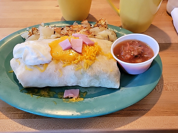 This breakfast burrito doesn't just say good morning—it shouts it with melted cheese, ham chunks, and a salsa sidekick that means business.