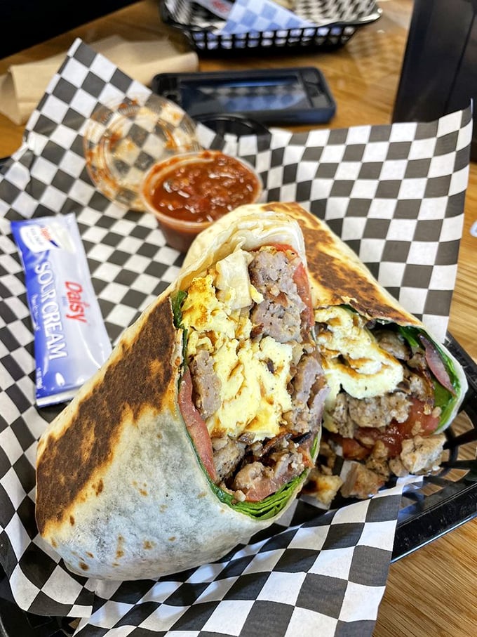 This breakfast burrito isn't just a meal, it's morning salvation wrapped in a tortilla – eggs, sausage, and cheese coming together like a sunrise symphony.