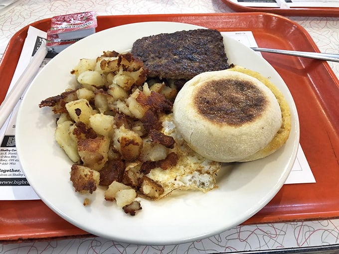 Breakfast perfection: crispy hash browns, savory sausage patty, and an English muffin sandwich that would make the Earl of Breakfast proud.
