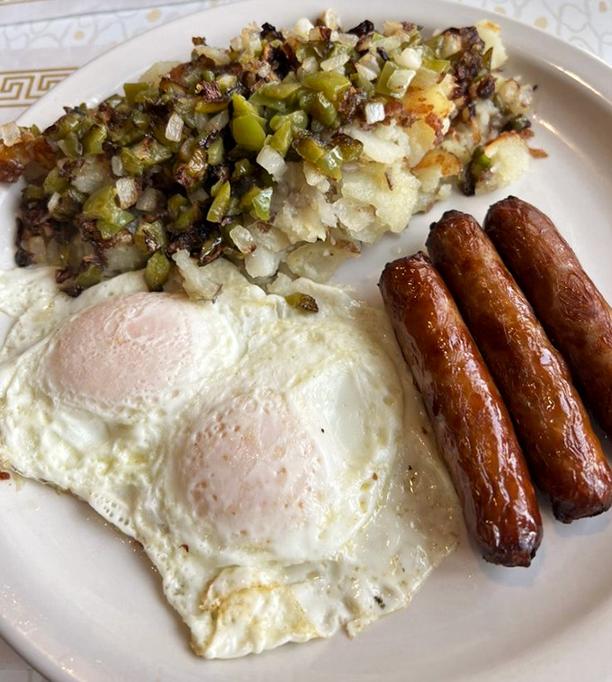 Home fries loaded with peppers and onions, perfectly cooked eggs, and sausage links that snap with joy—breakfast doesn't get more sincere than this.