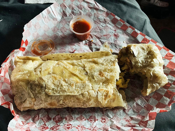 The breakfast burrito in its natural habitat: a styrofoam container that can barely contain all that savory, cheesy goodness.