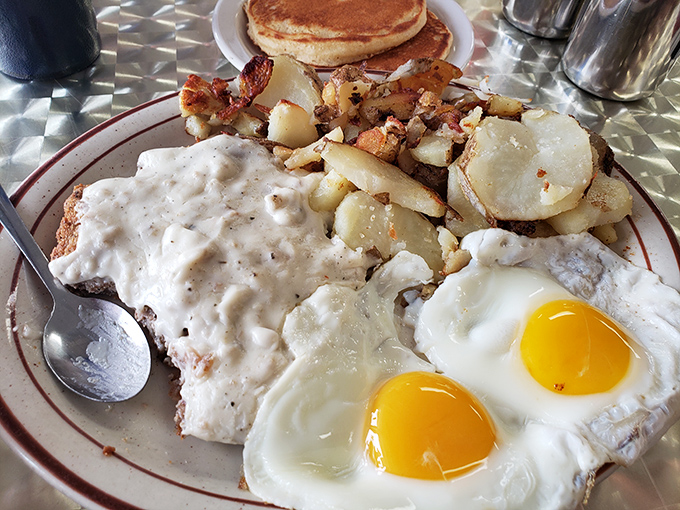 Eggs, potatoes, and gravy sharing a plate isn't just breakfast—it's a morning summit meeting of comfort food diplomacy.