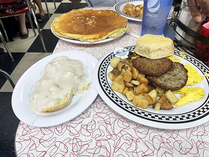 Breakfast harmony achieved: crispy hash browns, fluffy eggs, savory sausage, and that biscuit—a carb-loaded quartet performing breakfast's greatest hits.