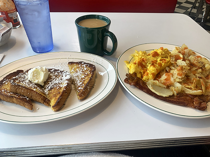 The breakfast trinity: golden French toast, fluffy scrambled eggs, and crispy bacon – proof that mornings can be wonderful after all.