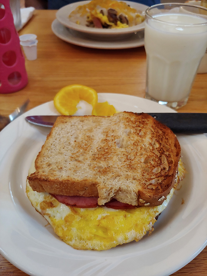The breakfast sandwich that launched a thousand road trips—perfectly toasted bread embracing eggs and ham like old friends at a reunion.