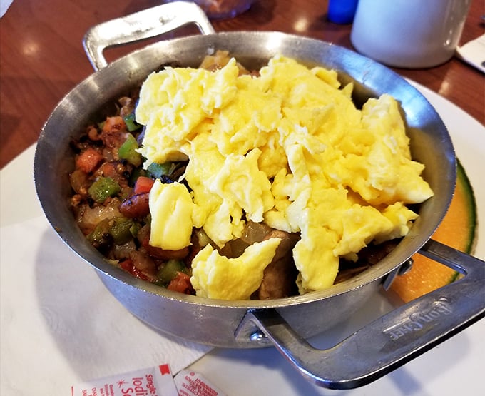 Breakfast skillet magic—where farm-fresh eggs crown a kingdom of perfectly seasoned vegetables and potatoes in cast iron splendor.