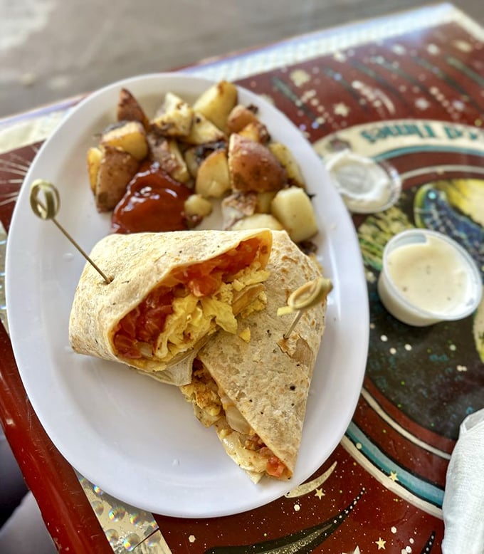 Breakfast wrapped up like a present waiting to be unwrapped. Those home fries on the side aren't just a garnish—they're co-stars.