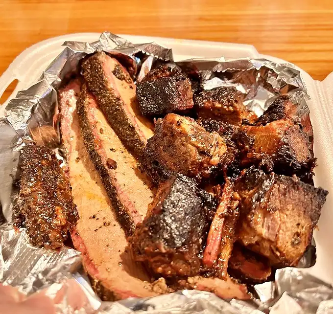 Brisket with a bark so perfect it deserves its own standing ovation. That smoke ring isn't just color—it's a flavor timeline.