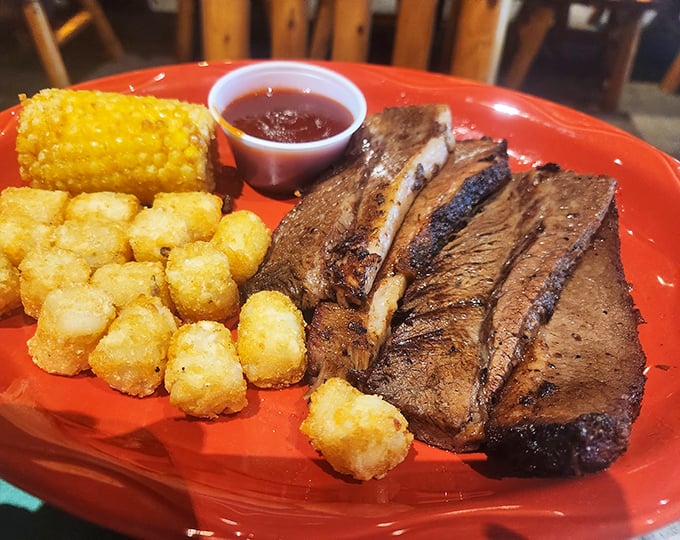 This brisket doesn't just fall apart—it surrenders completely, alongside crispy tater tots and corn that could make a Midwesterner weep with joy.