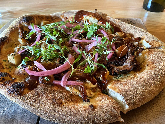 Pizza transcends to art form when wood-fired with toppings that tell a story—this brisket creation with red onions and microgreens would make any Italian grandmother nod approvingly.