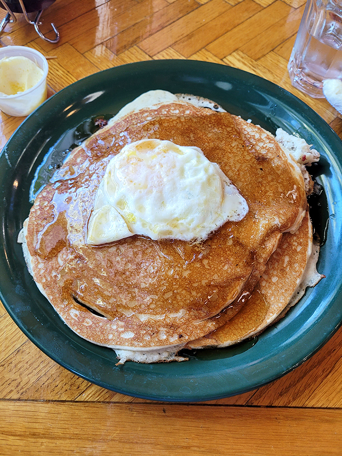 Pancakes topped with a perfect sunny-side-up egg—because sometimes breakfast needs to wear a hat to formal occasions.