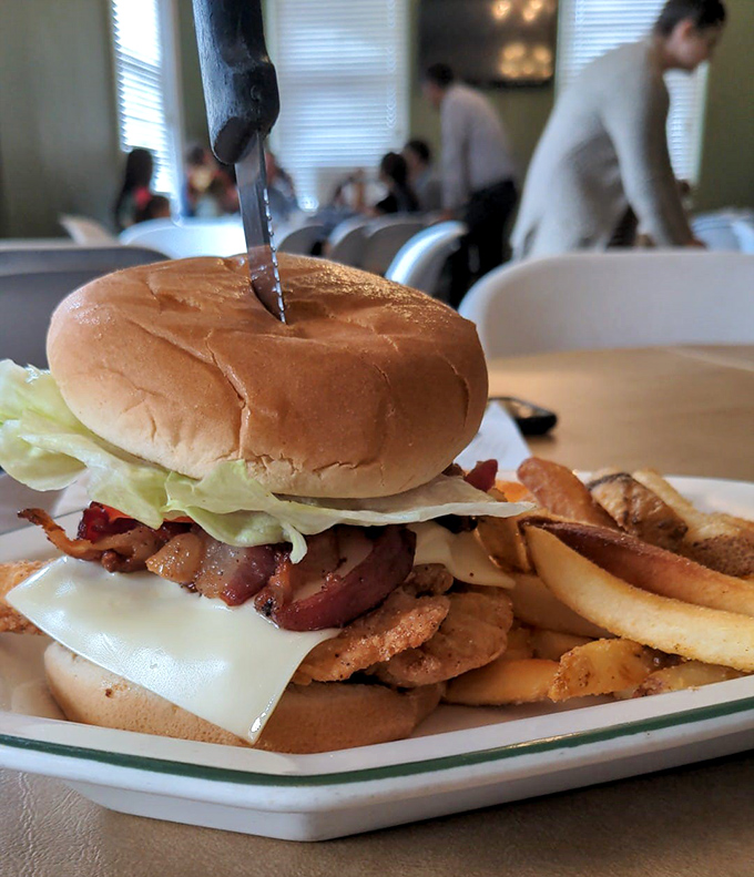 A burger that requires both hands and possibly a nap afterward. Those fries aren't just sides—they're co-stars in this lunch production.