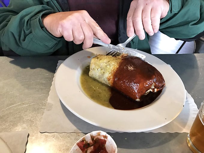 This isn't just a burrito—it's architecture. A masterpiece of culinary engineering draped in two contrasting sauces like a delicious yin-yang.