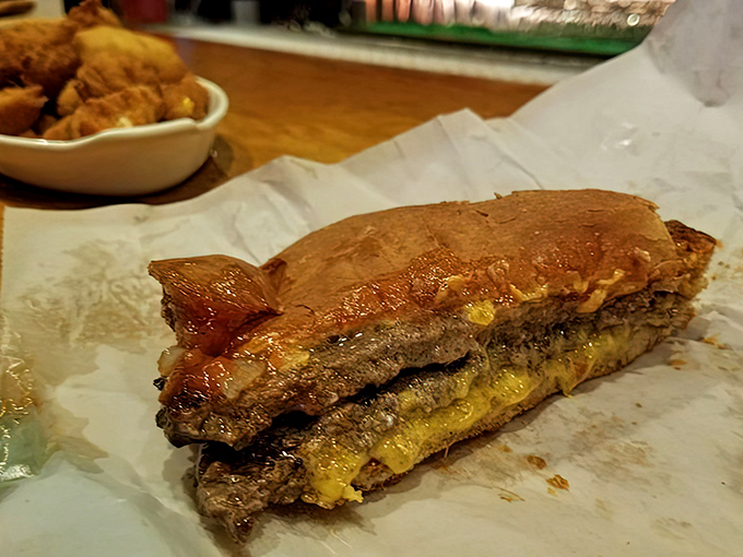 The legendary butter burger in all its glory—charcoal-grilled perfection where the cheese and beef perform a melty tango that would make Dancing with the Stars jealous.