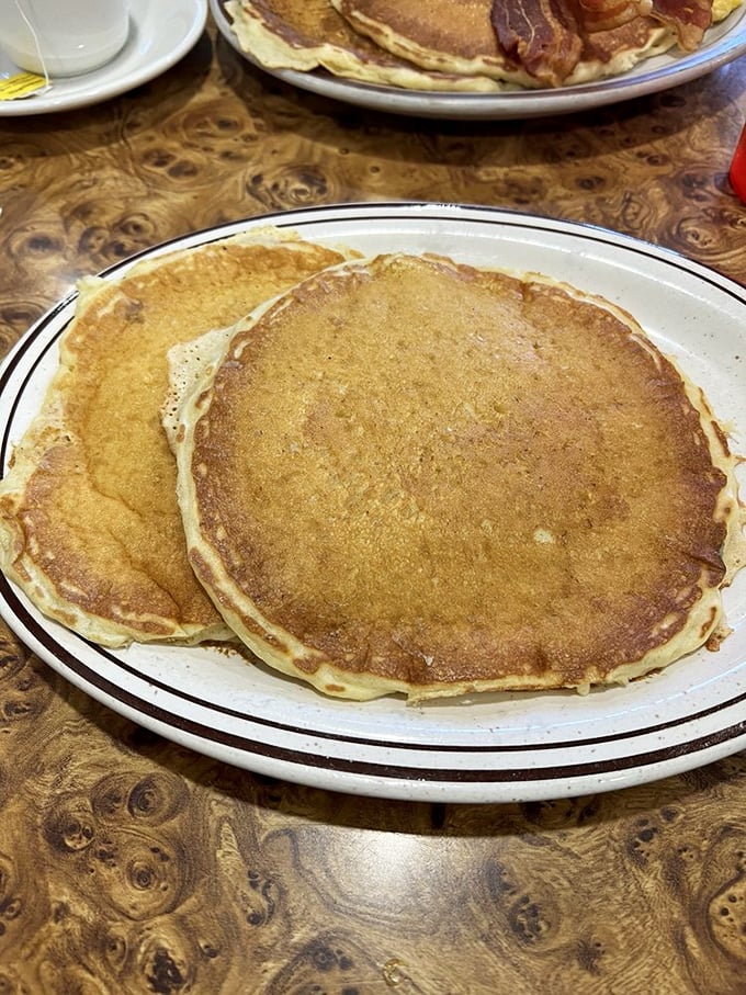 These buttermilk pancakes aren't just breakfast—they're edible sunshine with crispy edges and cloud-like centers that make mornings worth facing.