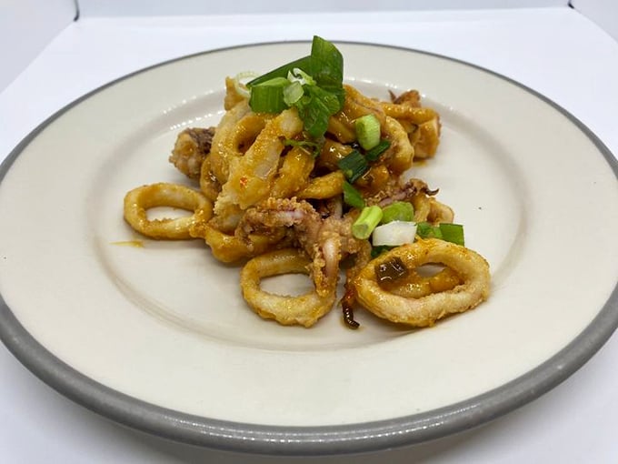 These calamari rings aren't just fried – they're given the royal treatment with a sprinkle of scallions that brightens every crispy bite.