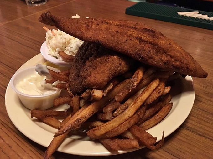 This isn't just fried fish—it's edible architecture. The perfectly golden-brown catfish stands tall over those legendary fries like a delicious monument to Lake Erie's bounty.