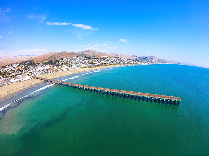 From this angle, Cayucos reveals its true colors—turquoise waters meeting golden shores, with that magnificent pier stealing the show.