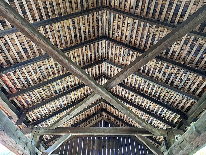 Look up and marvel at the geometric precision of yesteryear. No computer designs here—just human ingenuity and hand-hewn timber creating functional art.