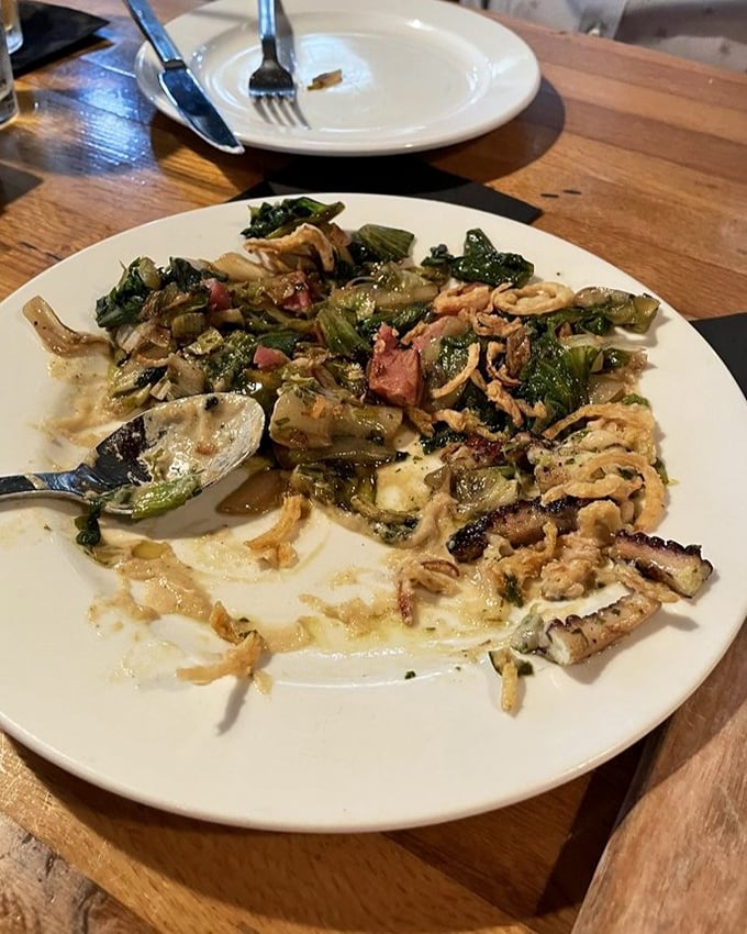 The charred octopus doesn't just arrive—it makes an entrance. Those crispy edges and vibrant vegetables are having their own little garden party.